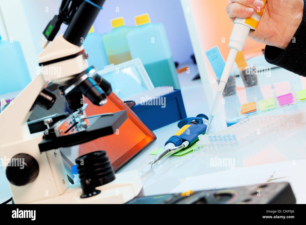 Scientist filling vials in a multiwell sample tray in a plant lab Stock ...