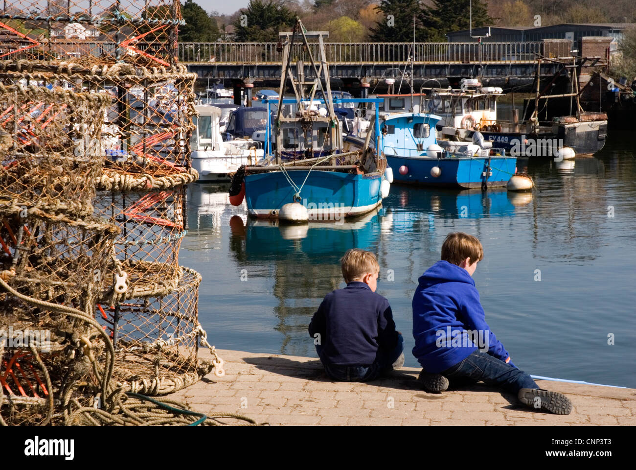 Lymington - Hants - the harbour wall - small boys fishing for crabs ...
