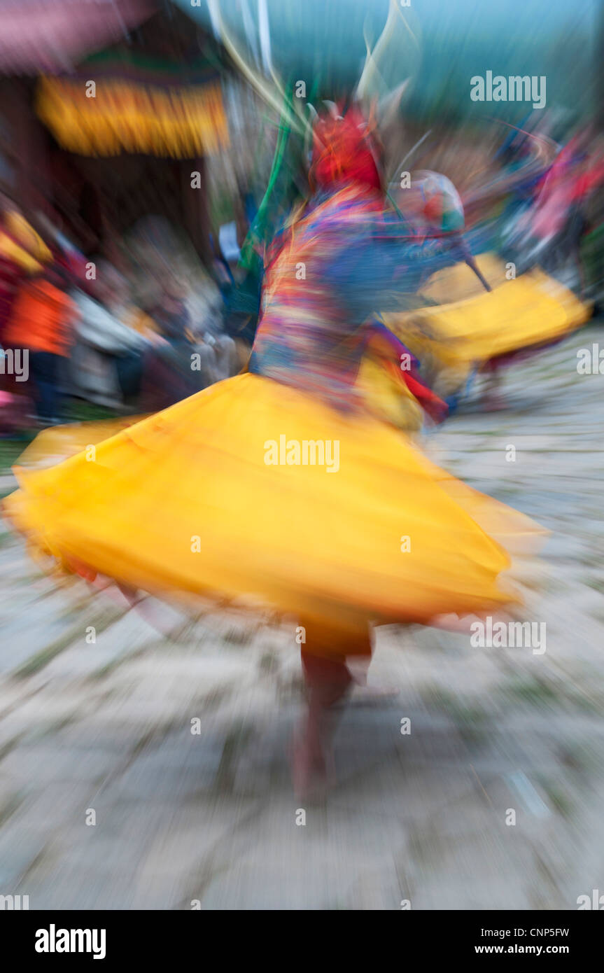 Asia, Bhutan, Bumthang. Twirling dancer at Domkhar Tshechu festival ...
