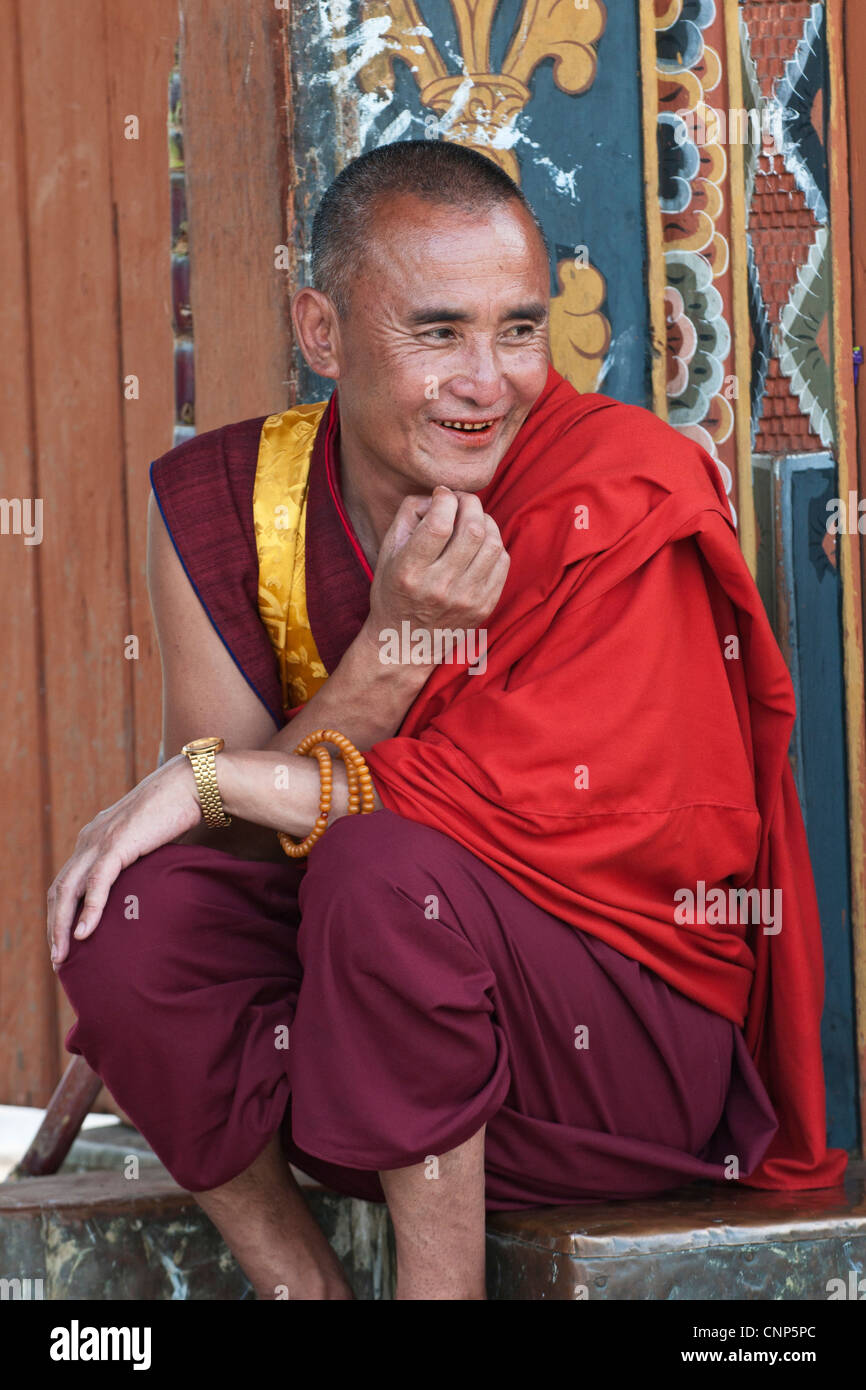 Asia, Bhutan, Punakha. Portrait of sitting monk in Punakha Dzong ...
