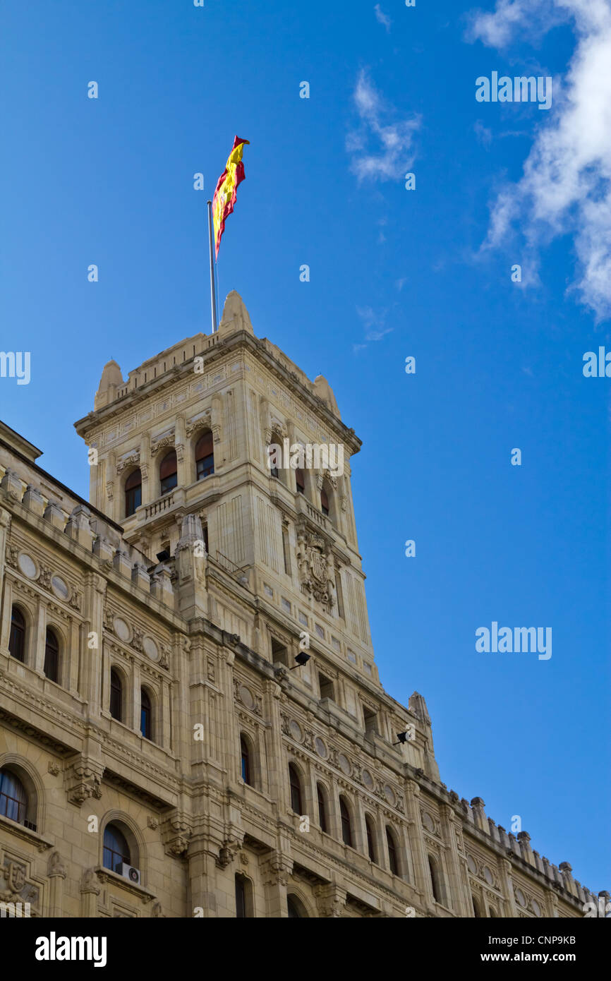 An ancient spanish building with the national flag on it Stock Photo ...