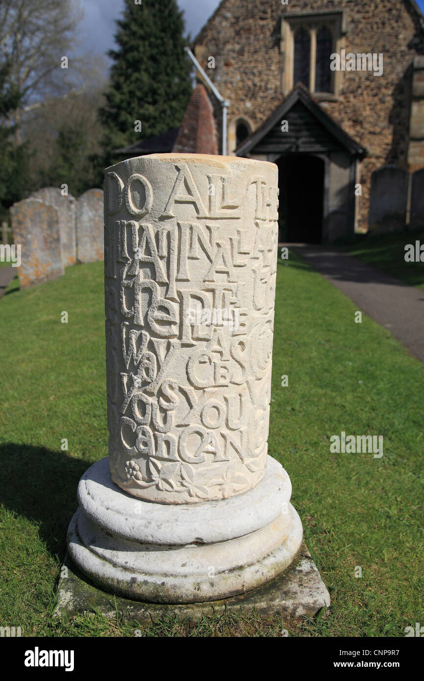 Millennium stone in the churchyard of St. James in Shere, Surrey Hills ...