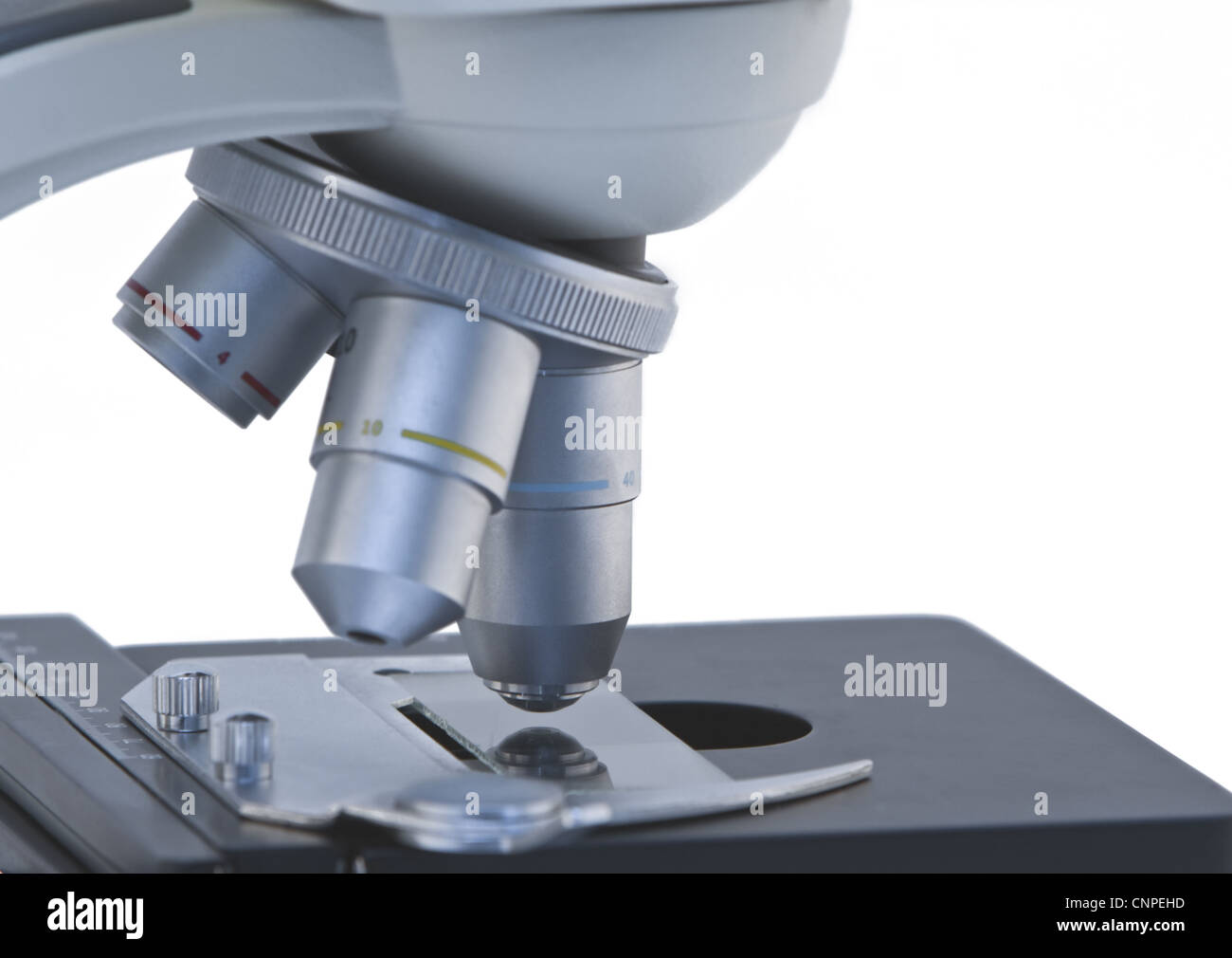 Close-up image of microscope lenses isolated against a white background ...