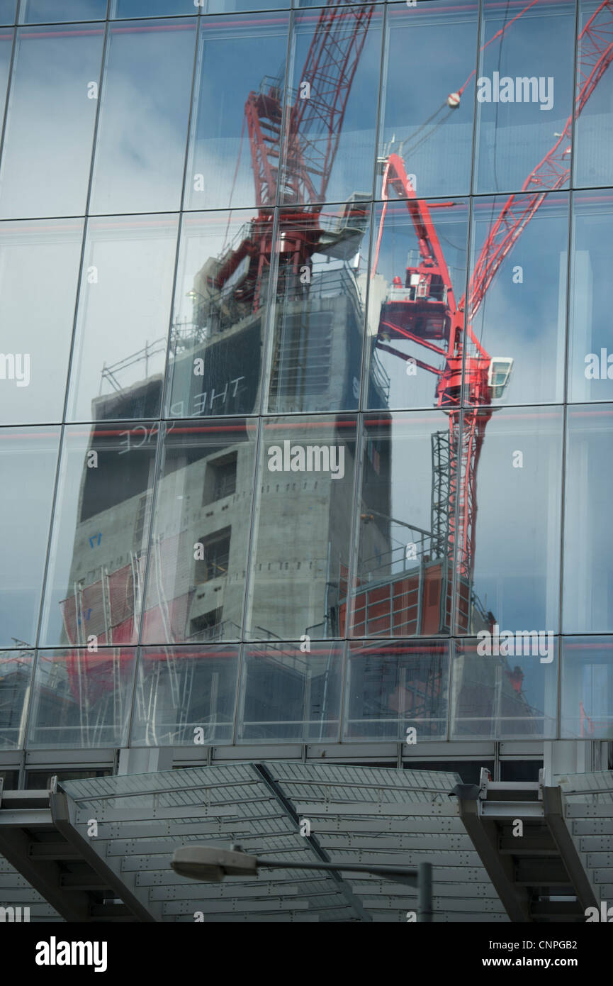 One The Place, a new building being constructed can be seen reflected ...