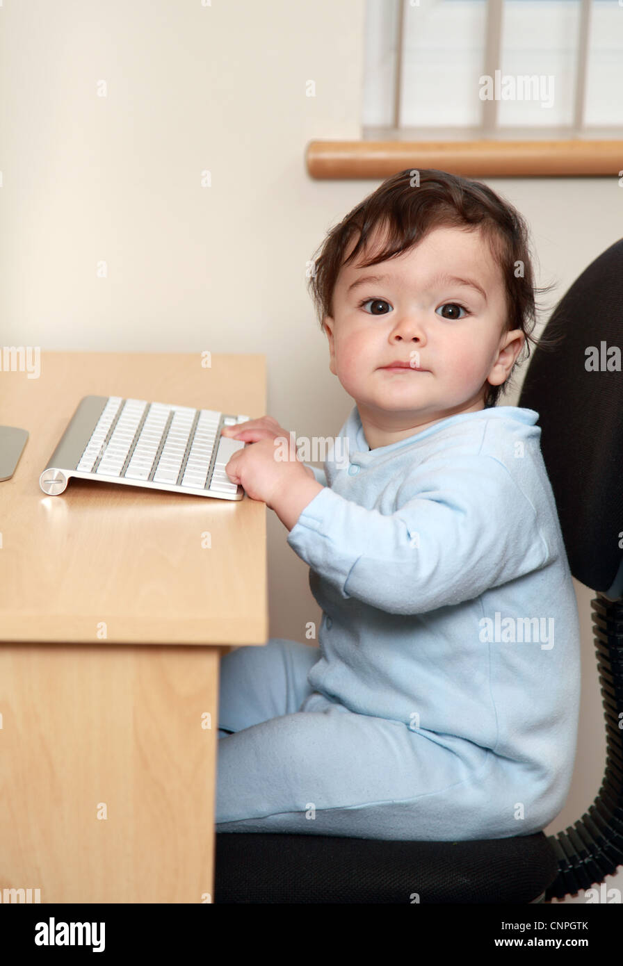 Adorable baby using computer Stock Photo - Alamy
