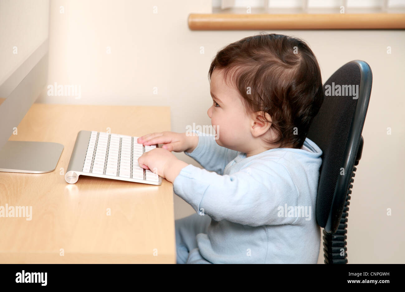 Toddler typing on keyboard Stock Photo - Alamy