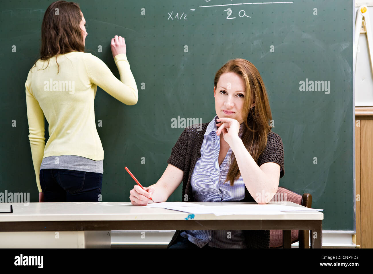 portrait of a young female teacher in the classroom Stock Photo - Alamy