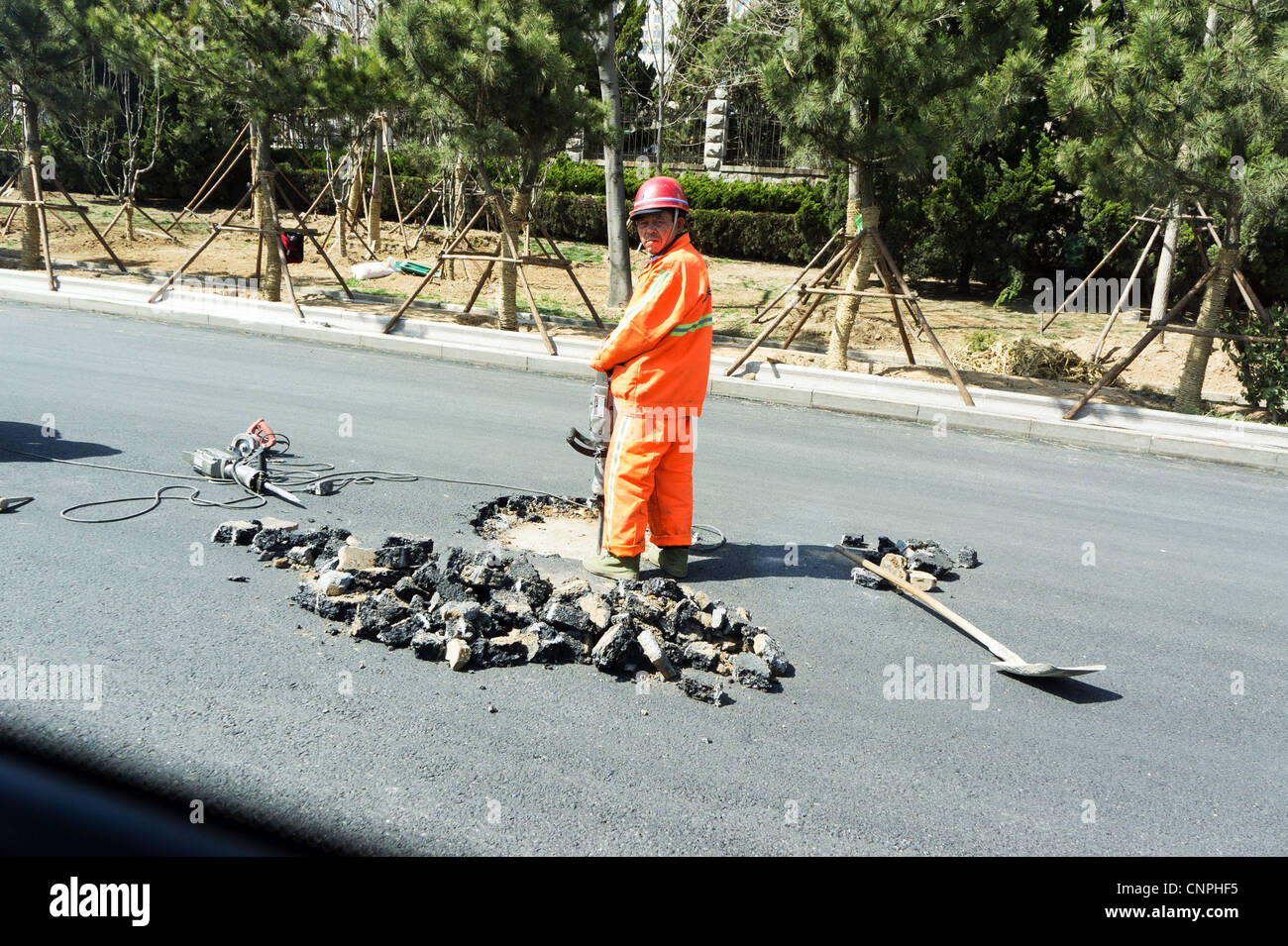 Chinese worker using pneumatic drill in road, Qingdao, China Stock ...