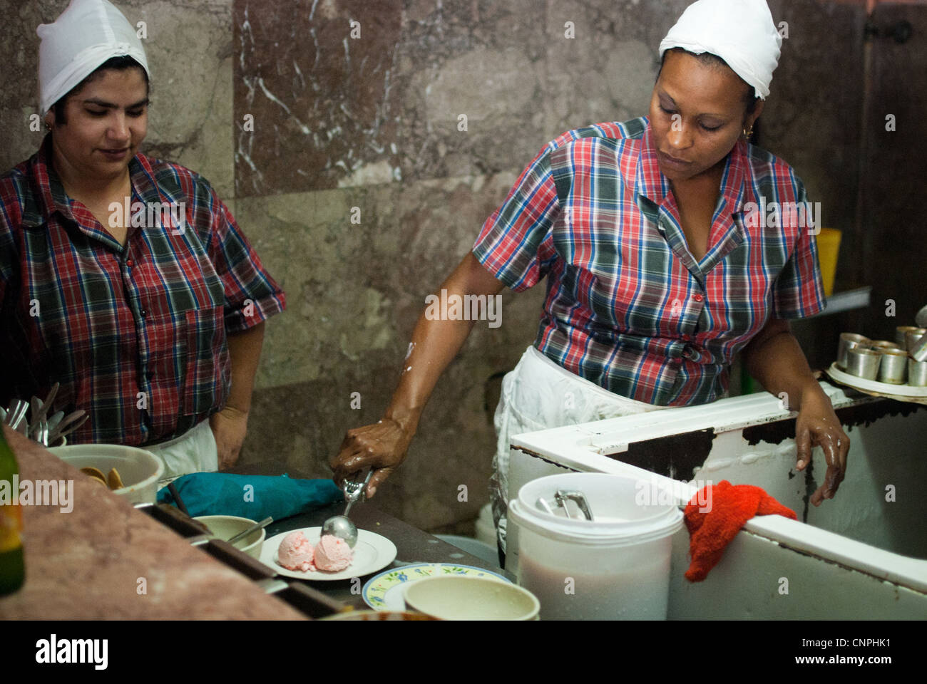 Two Cuban women working serving ice cream in Coppelia, Santa Clara ...
