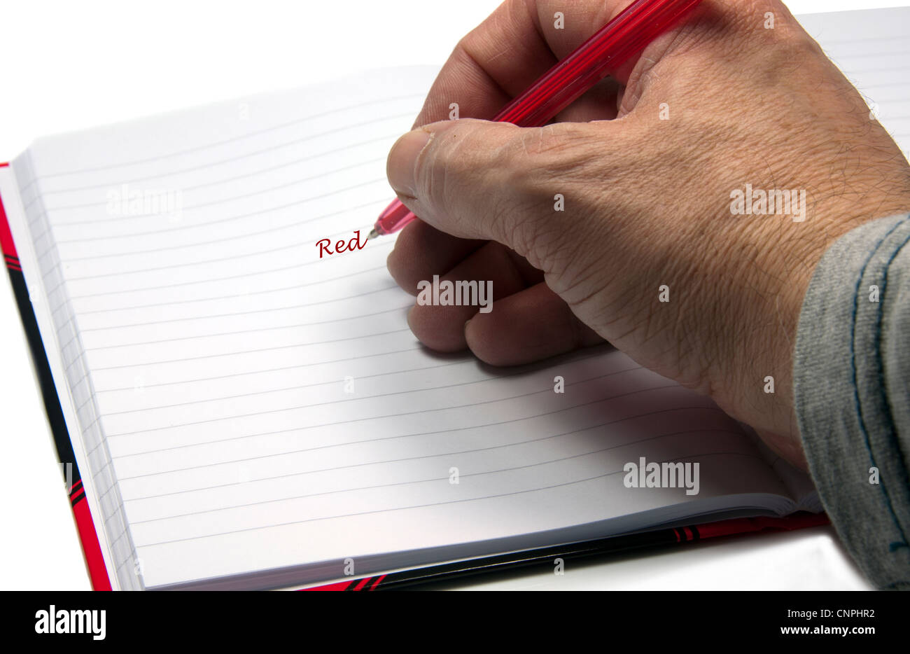 hand with a pen writing red Stock Photo - Alamy