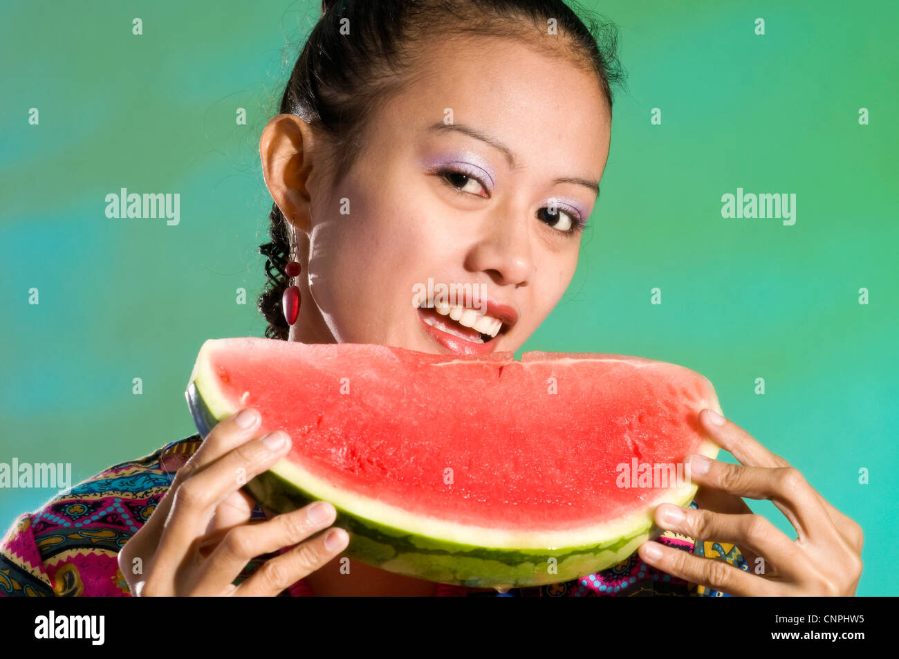 asian girl with water melon in studio setting Stock Photo - Alamy