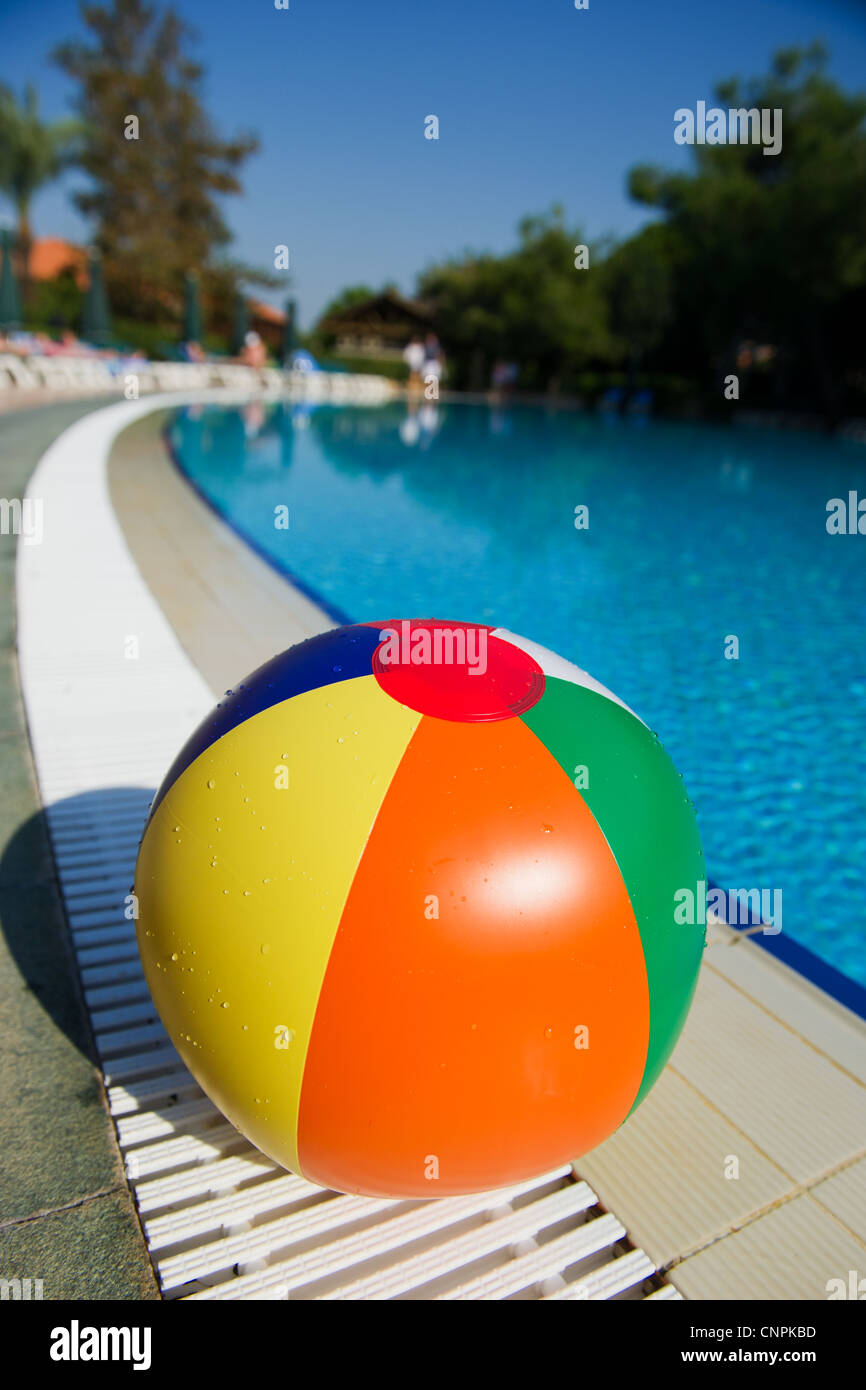 Beach ball laying near the outdoor swimming pool Stock Photo - Alamy