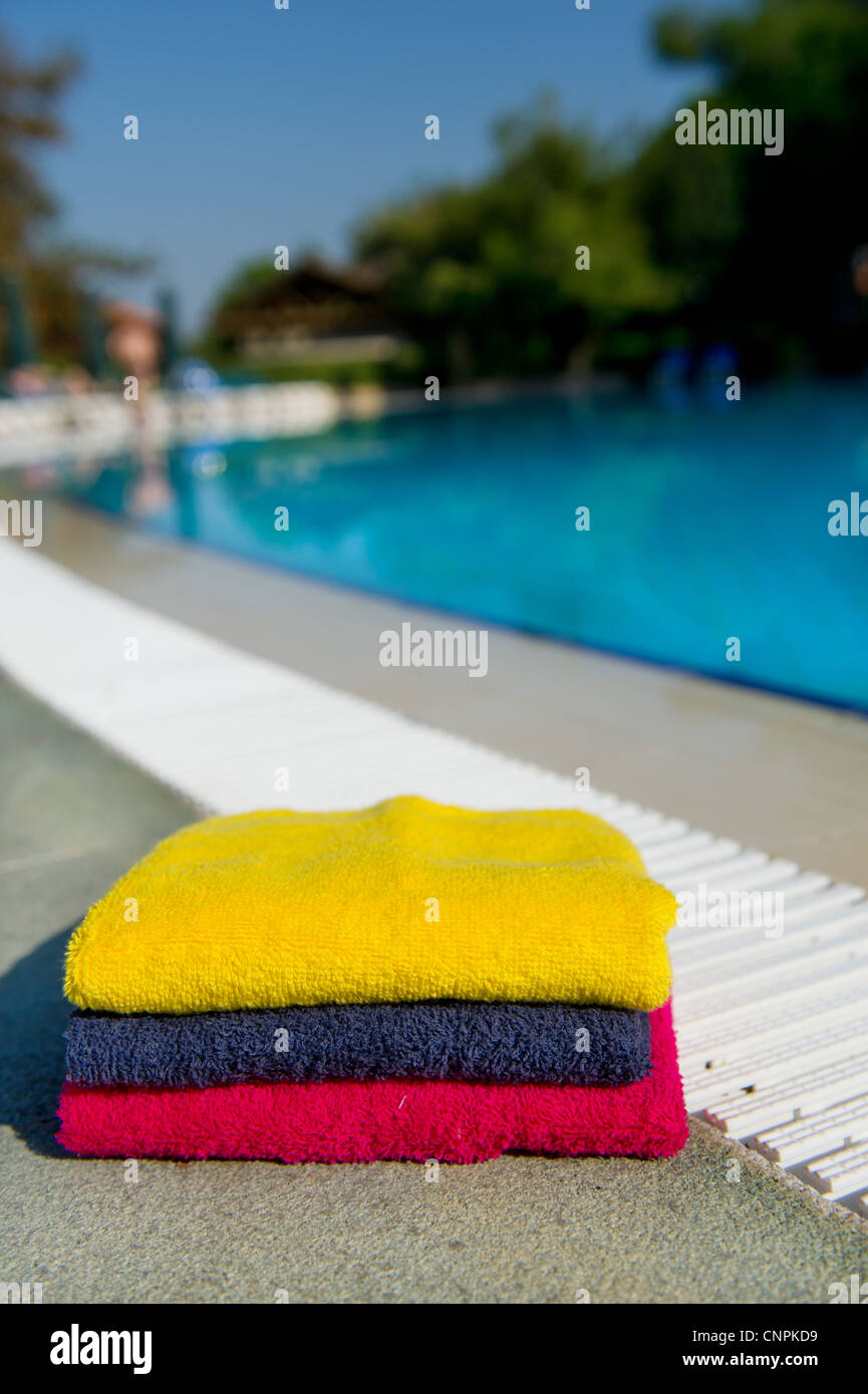 Colorful stacked towels near the swimming pool Stock Photo - Alamy