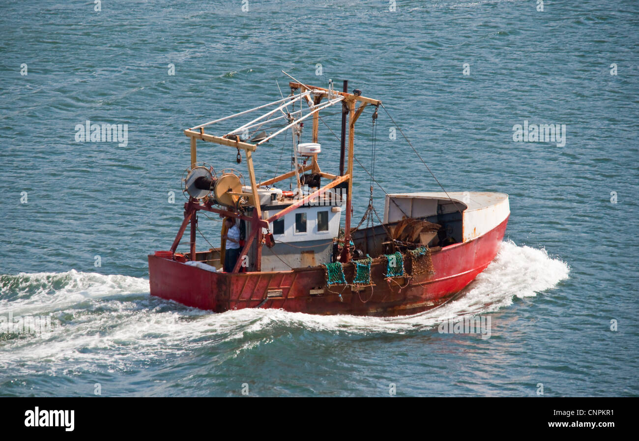 A fishing boat heading out to sea Stock Photo - Alamy