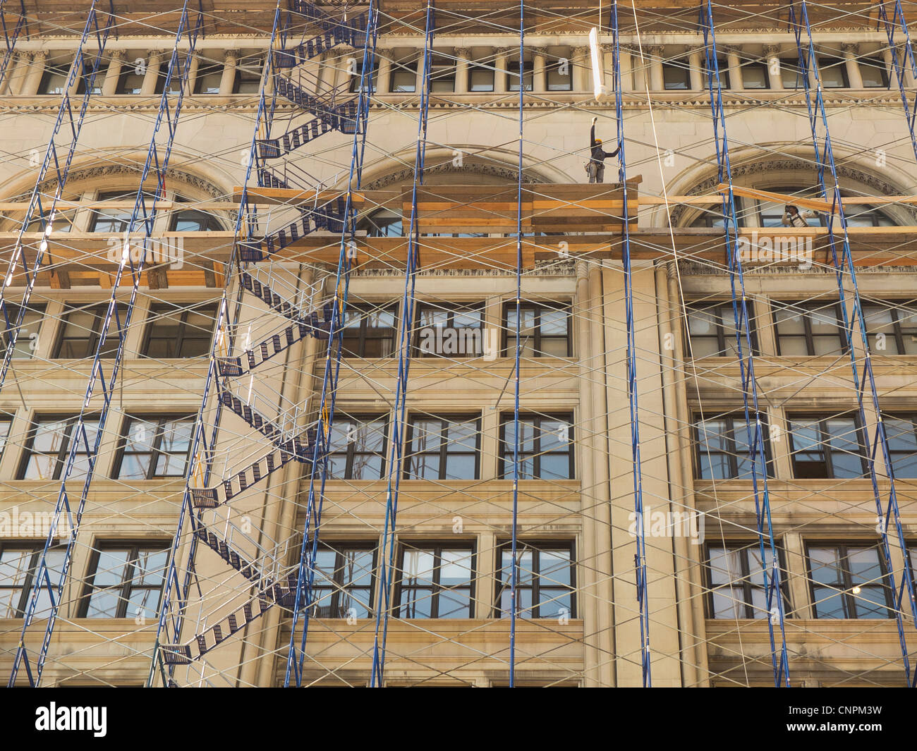 construction workers on scaffolding on an apartment building in ...