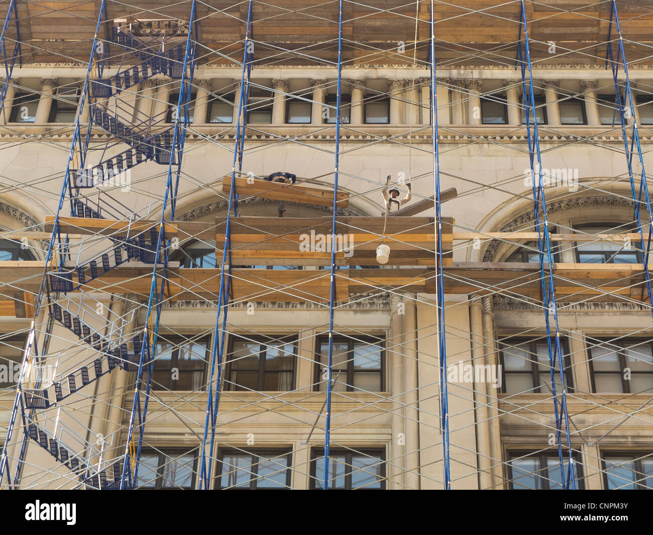 construction workers on scaffolding on an apartment building in ...
