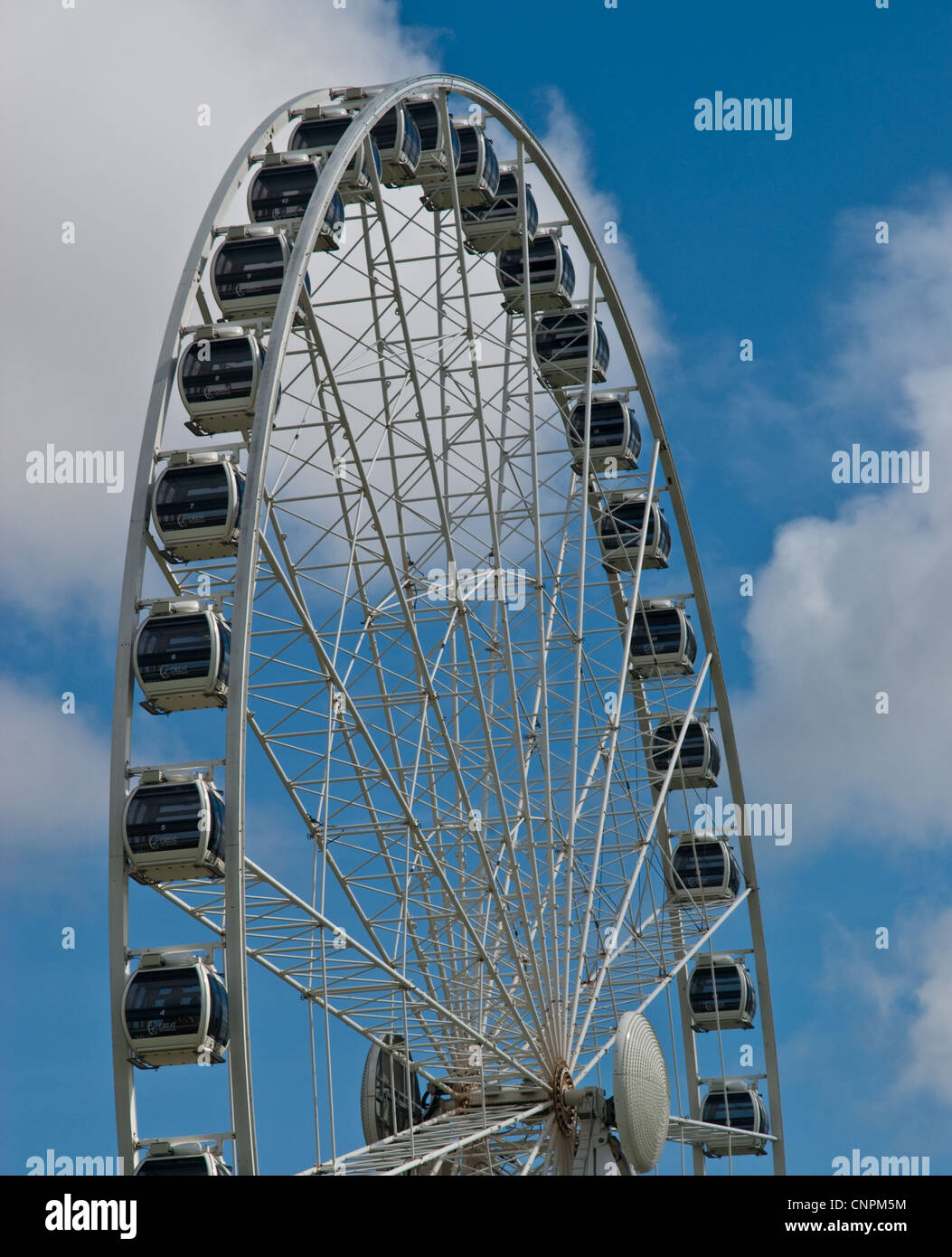 A big wheel with viewing pods going round Stock Photo - Alamy
