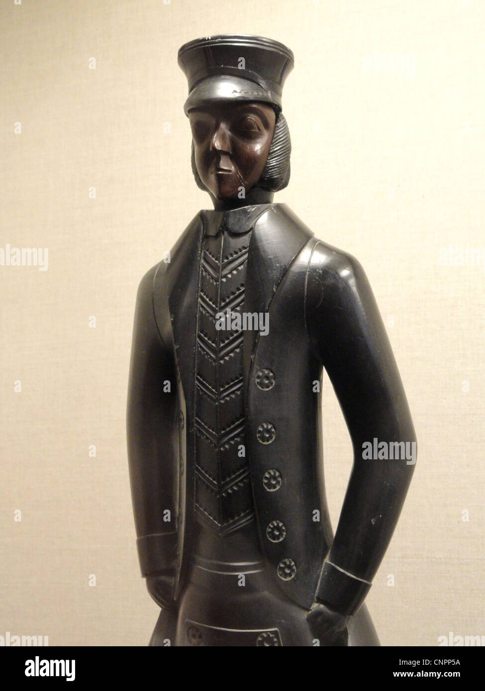 This figurine of a European sea captain, carved from slate, was created ...