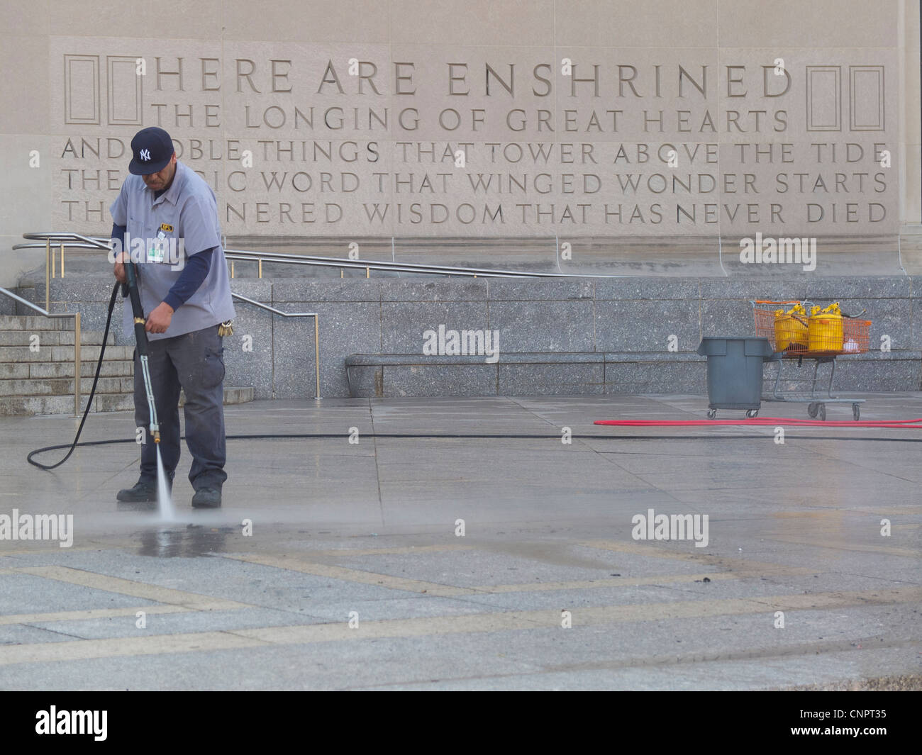cleaning the sidewalk in front of the main branch of the Brooklyn ...