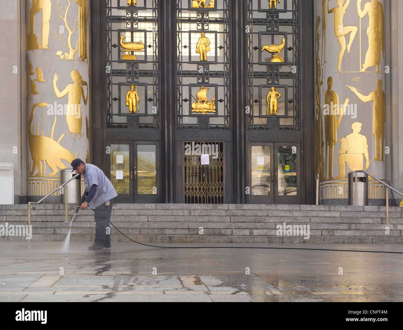 cleaning the sidewalk in front of the main branch of the Brooklyn ...