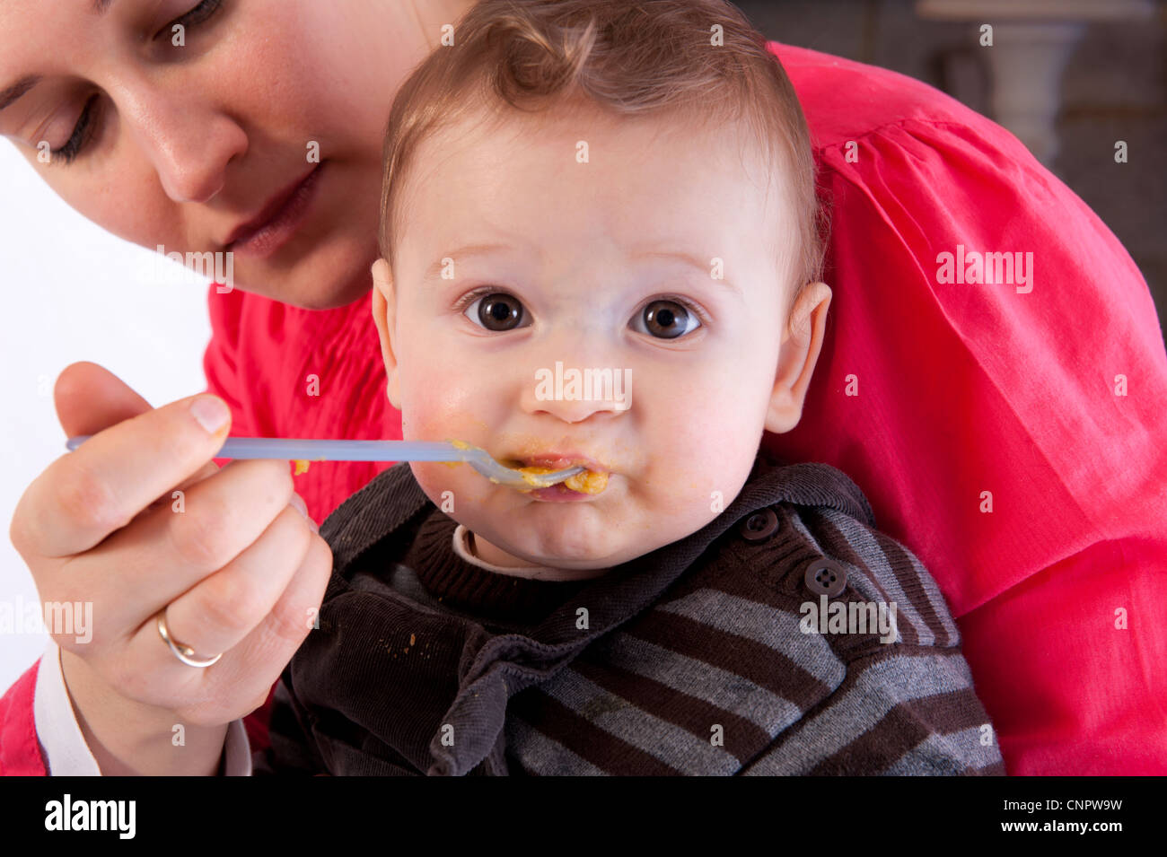 mother feeding her baby boy Stock Photo - Alamy
