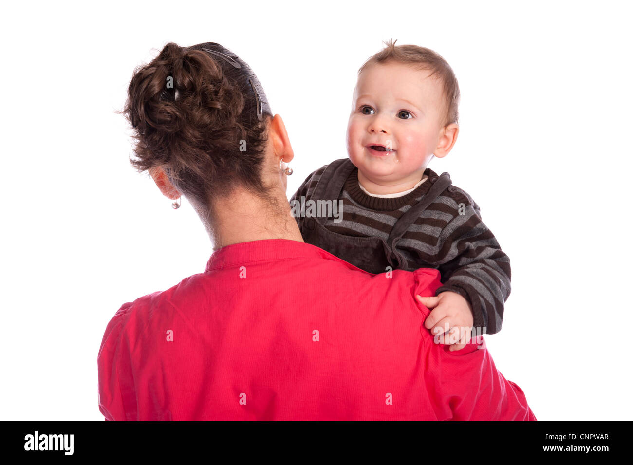 Baby looking over his mother's shoulder. On white background Stock ...