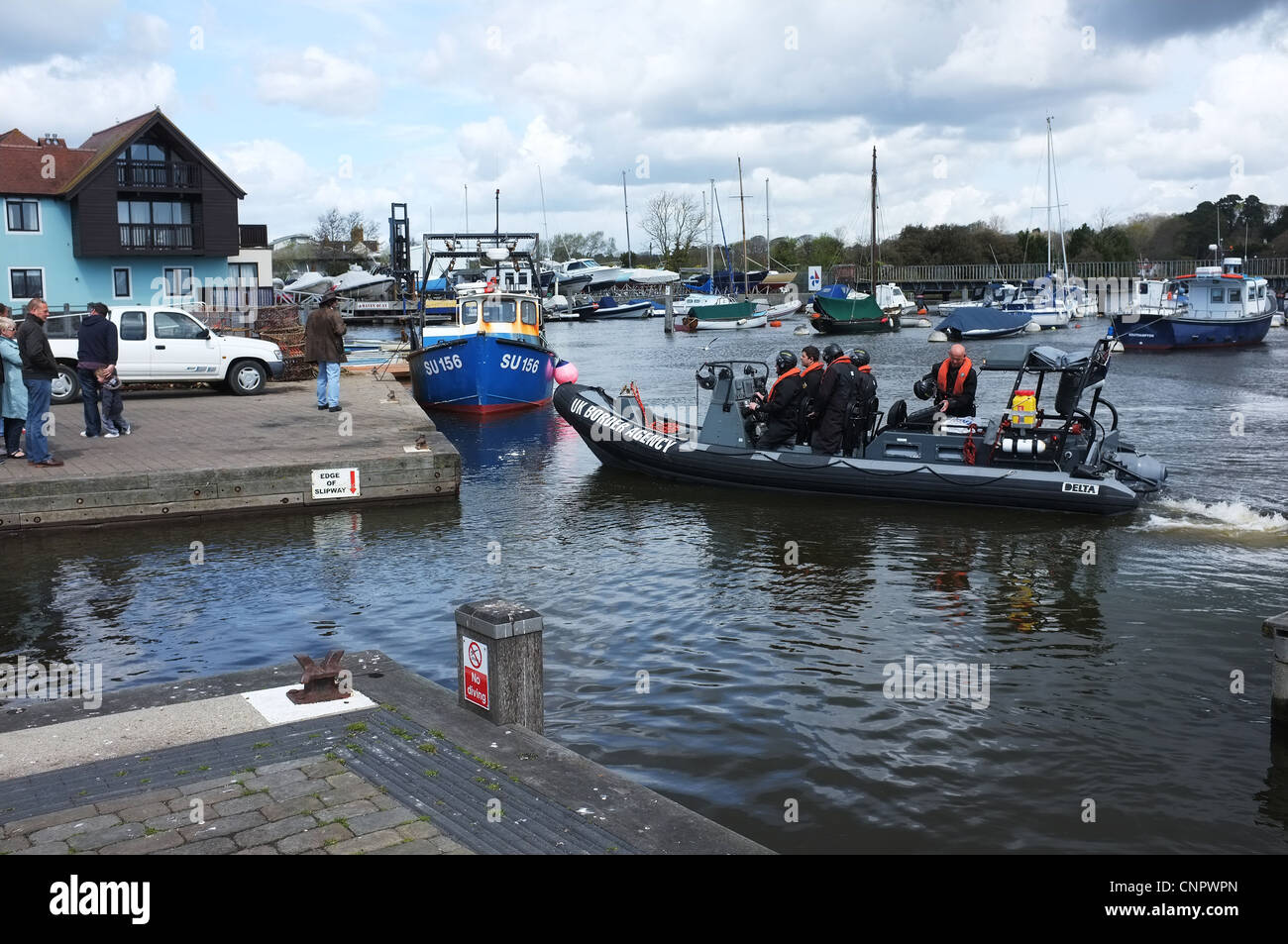 United Kingdom Borders Agency Officers, in a patrol boat, approach the ...