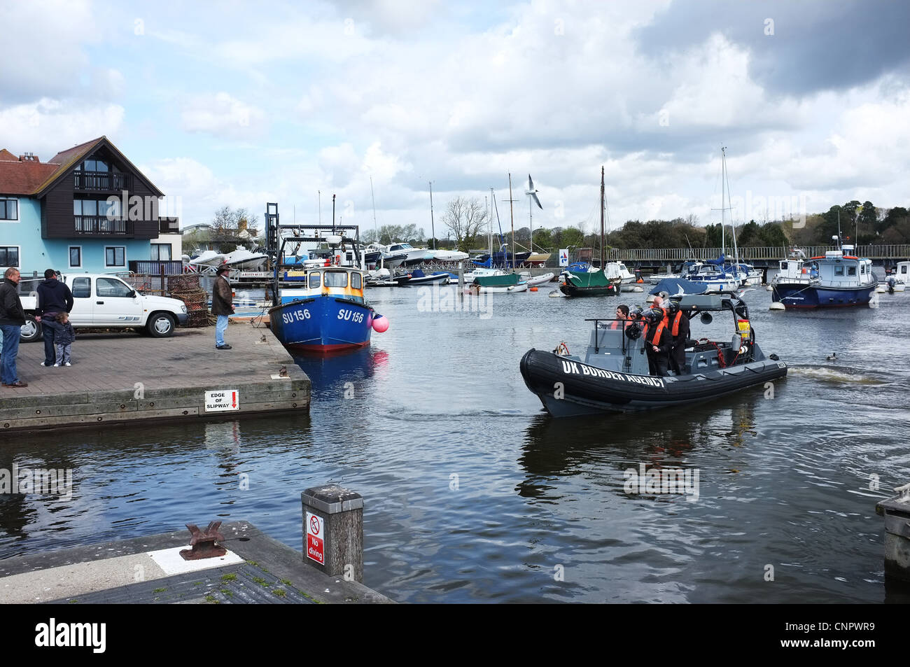 United Kingdom Borders Agency Officers, in a patrol boat, approach the ...