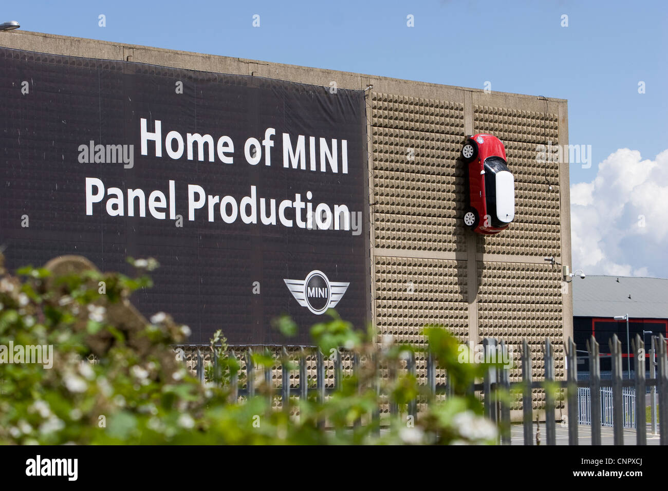 BMW mini car on vertically stuck to the wall at the BMW panel pressing ...