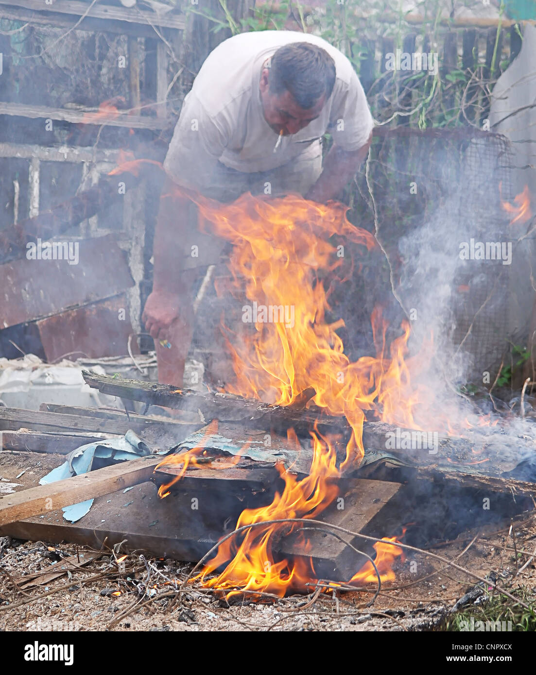 Smoking reason of Fire toxic flame and man trying put fire out Stock ... Smoking reason of Fire toxic flame and man trying put fire out Stock ...