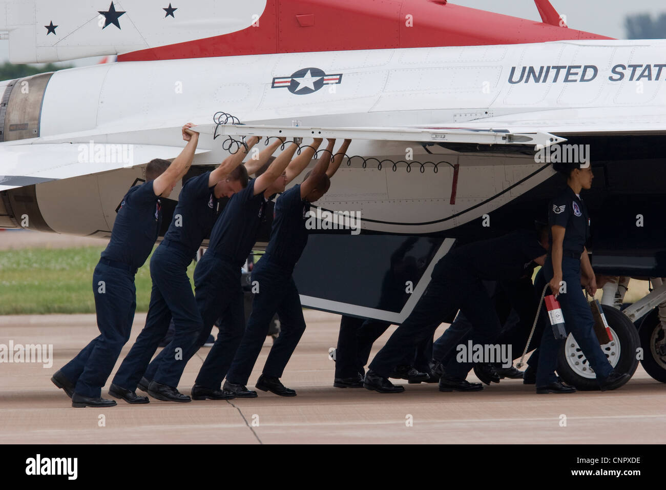 Ground crew pushing an F16 fighter jet, one of the aircraft in the USAF ...