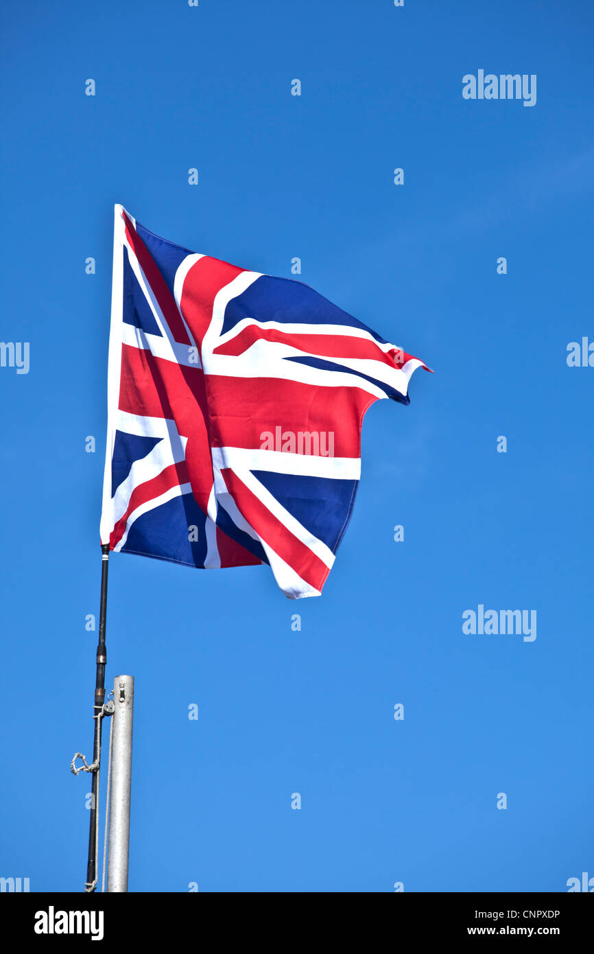 Union Flag Flying Against Clear Blue Sky Stock Photo - Alamy