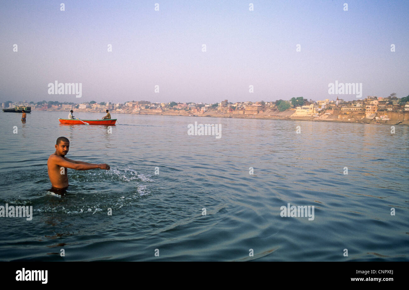 Man bathing in the river Ganges at the ancient Indian city of Benares ...