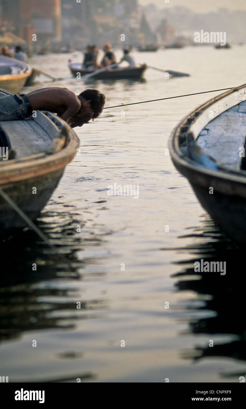 Man washing his face in the river Ganges at the ancient Indian city of ...
