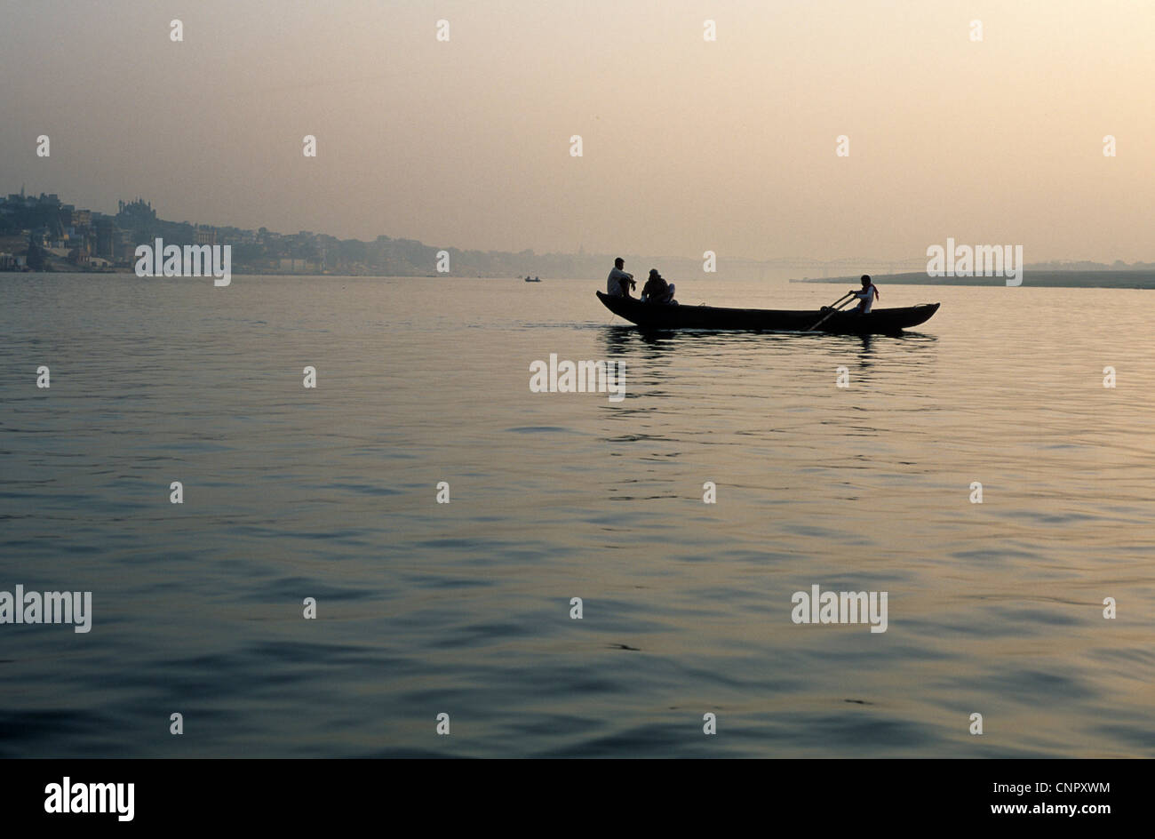 Boat sailing the Ganges at sunrise at the ancient Indian city of ...
