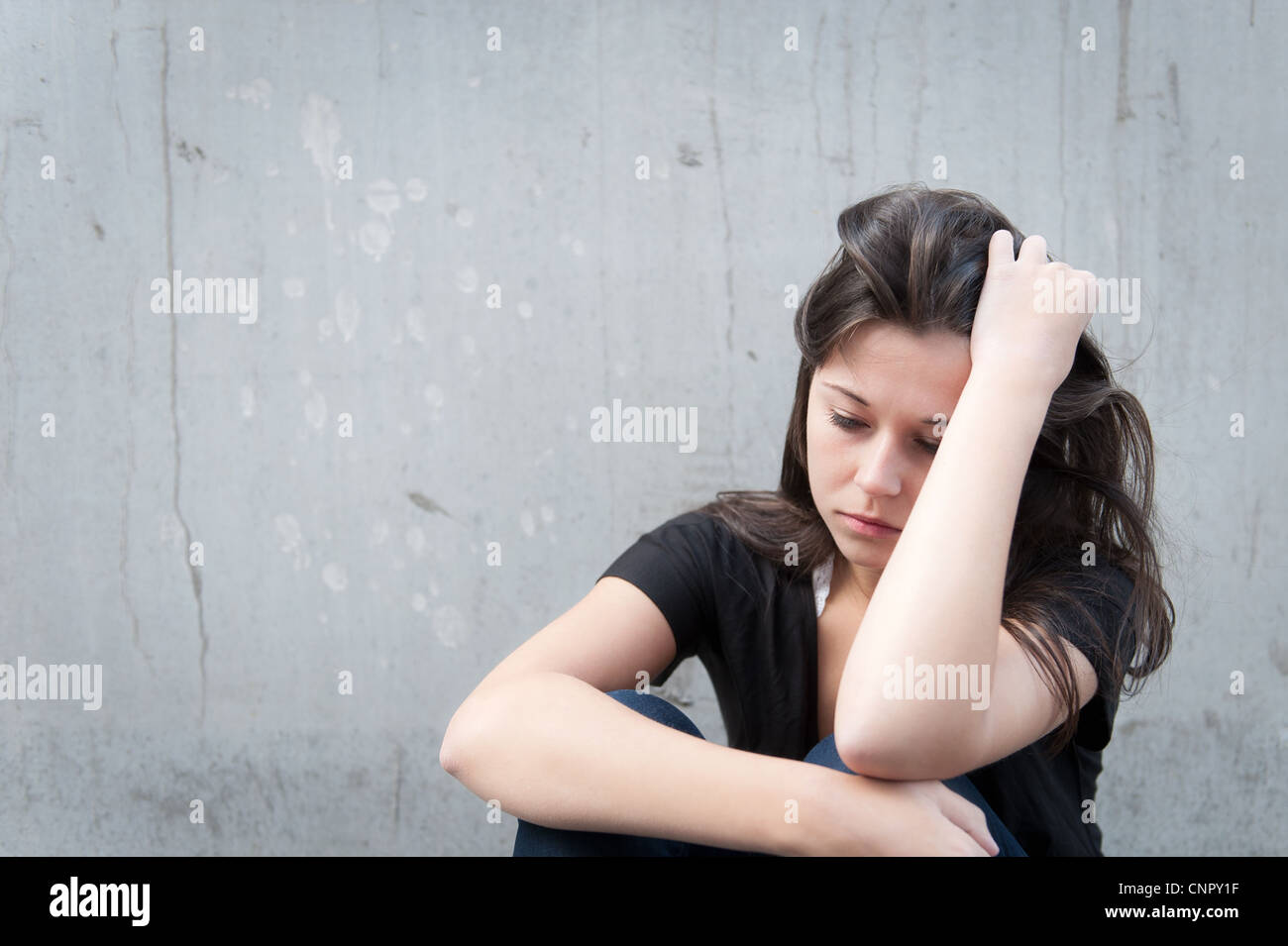 Outdoor portrait of a sad teenage girl looking thoughtful about ...