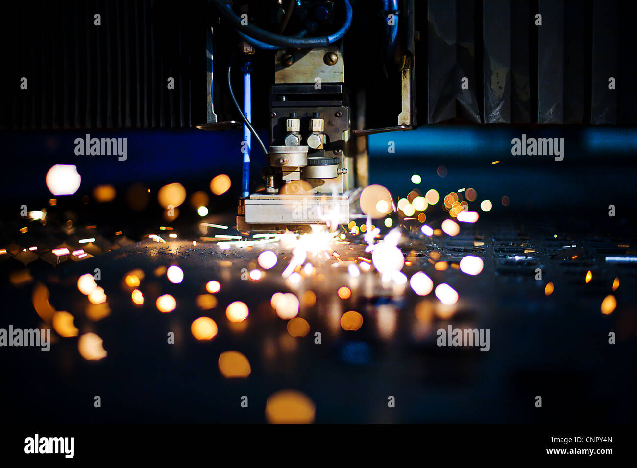 Laser cutting with sparks close up Stock Photo - Alamy