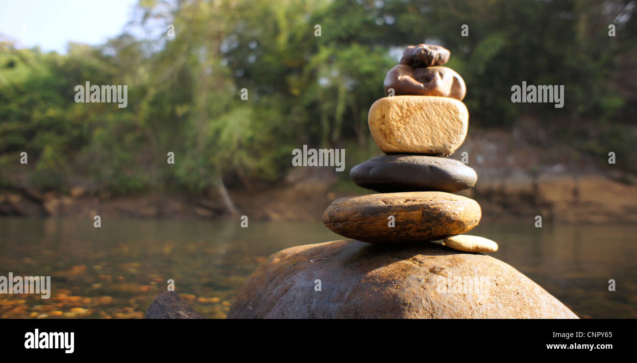 balanced stack of rocks with rocky background Stock Photo - Alamy