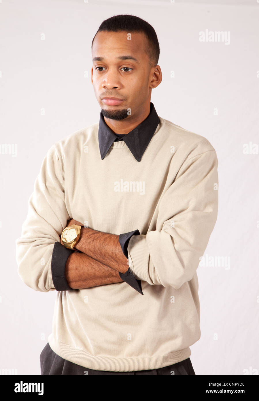 Handsome young black man with pensive expression looking to the left ...