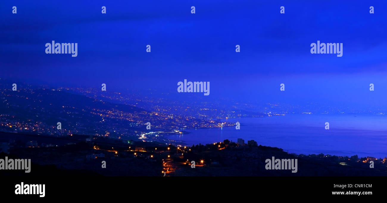 Panoramic mountains city at night with blue sky & sea Stock Photo - Alamy