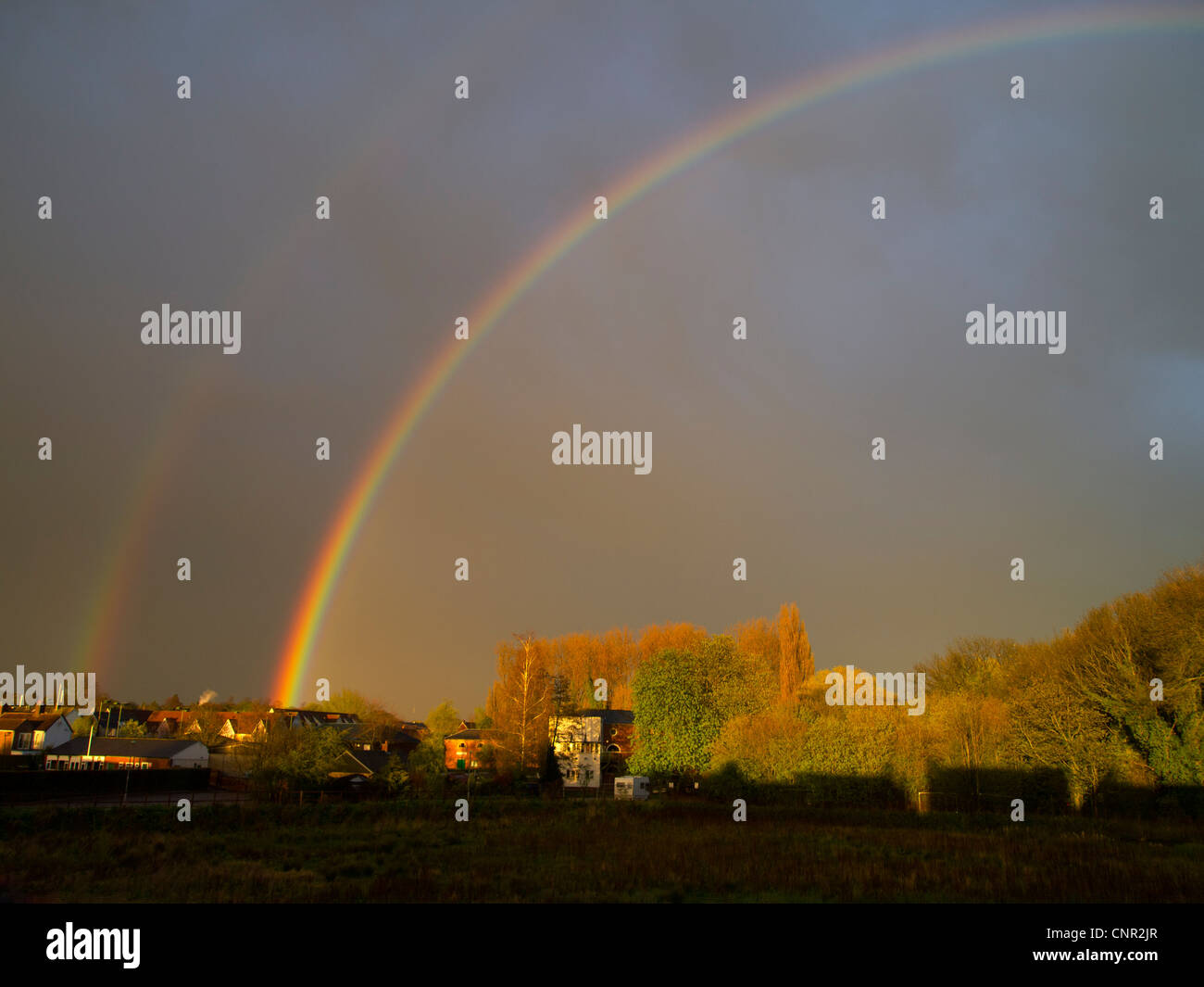 An early-evening rainbow seen against the backdrop of a brooding sky ...