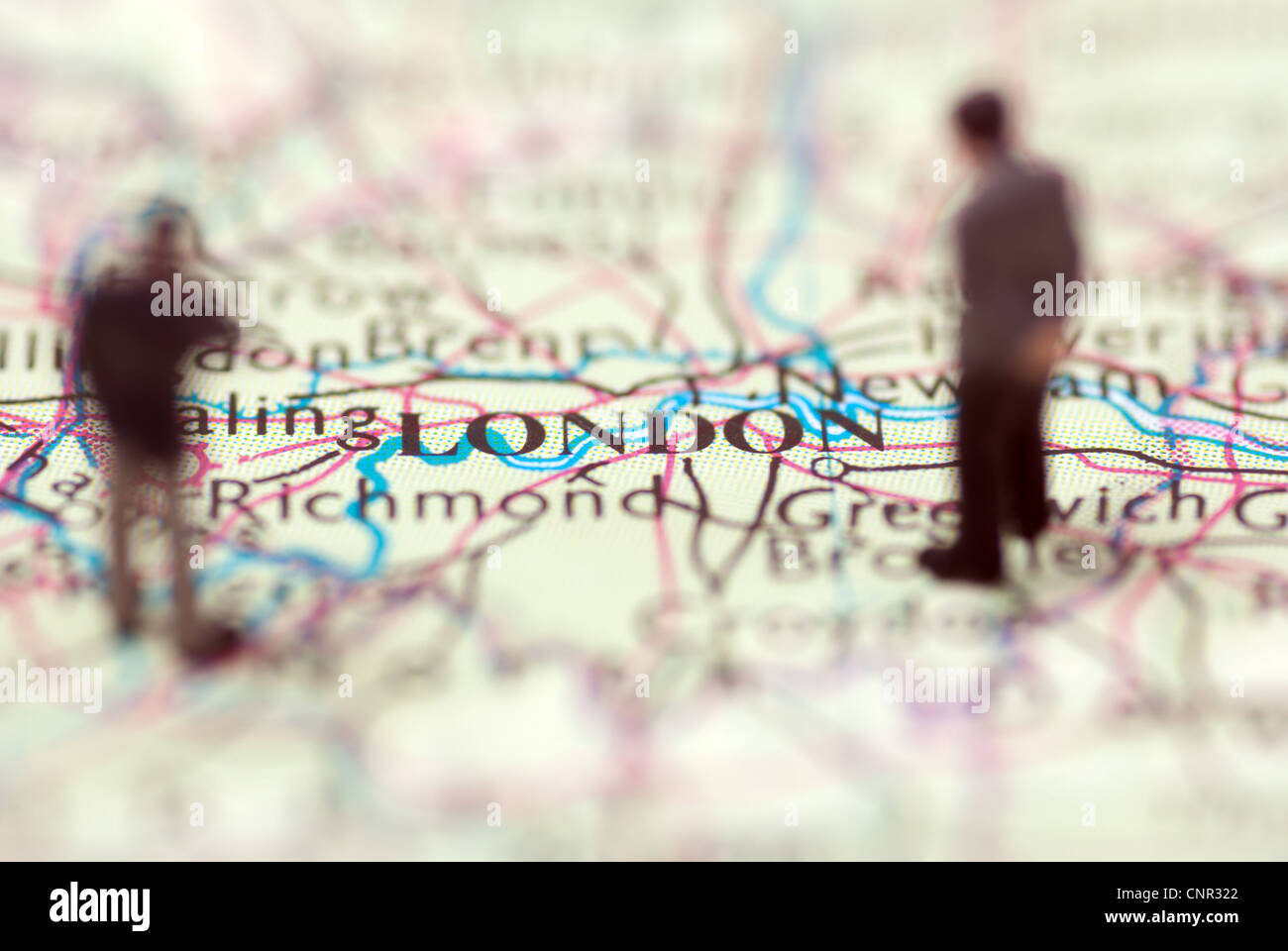 Conceptual image of a model figures of a businessmen looking at London ...