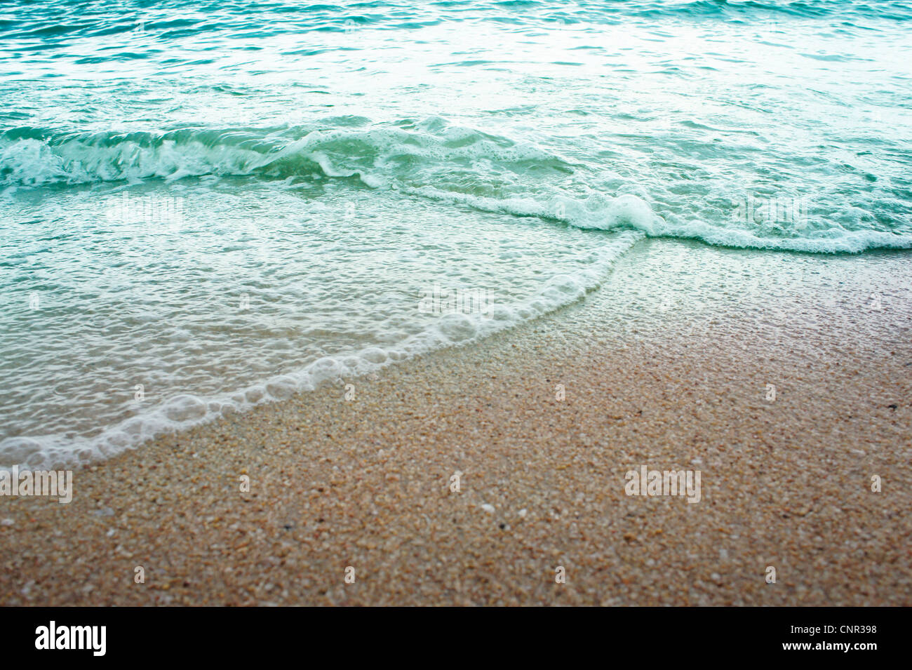 Sand beach water Wave background Stock Photo - Alamy