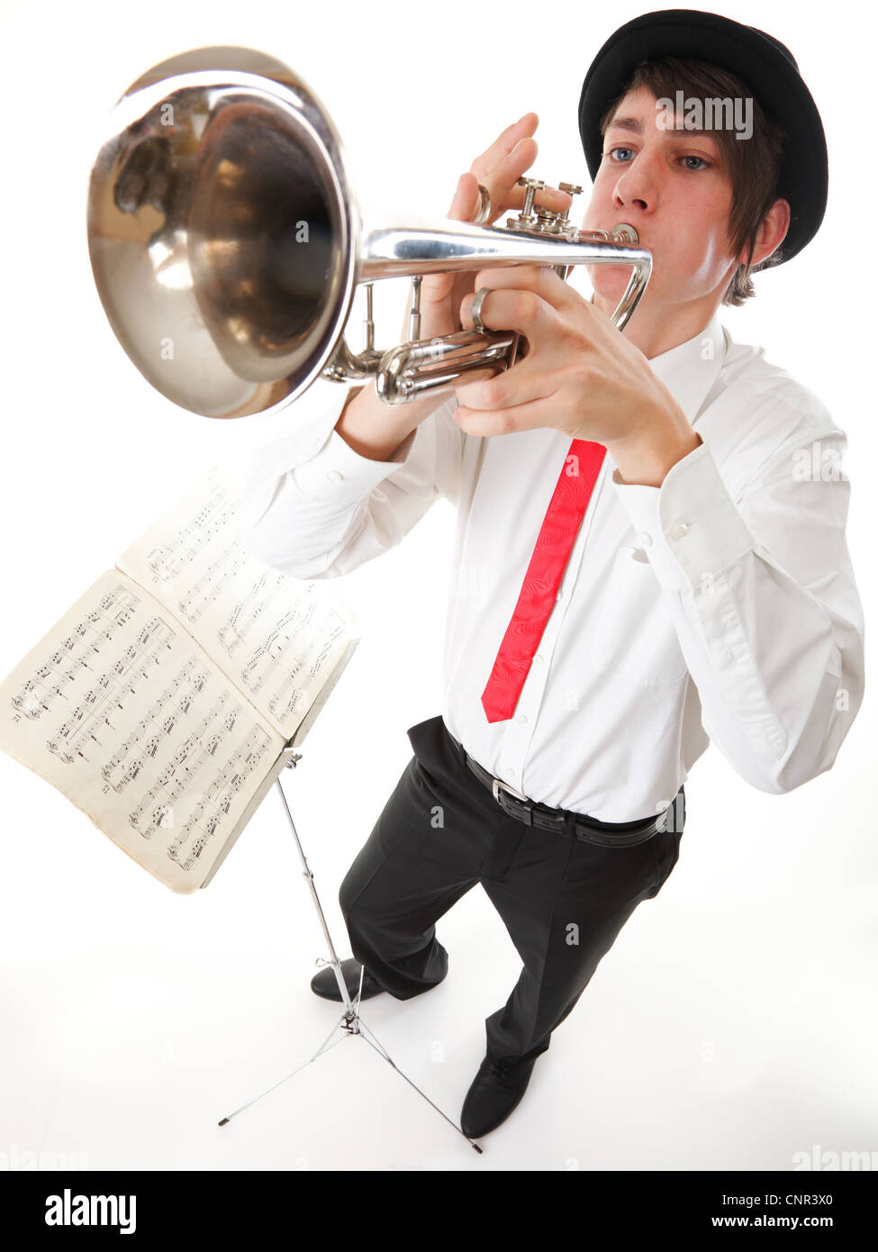 Portrait of a young jazz man playing his Trumpet white background Stock ...