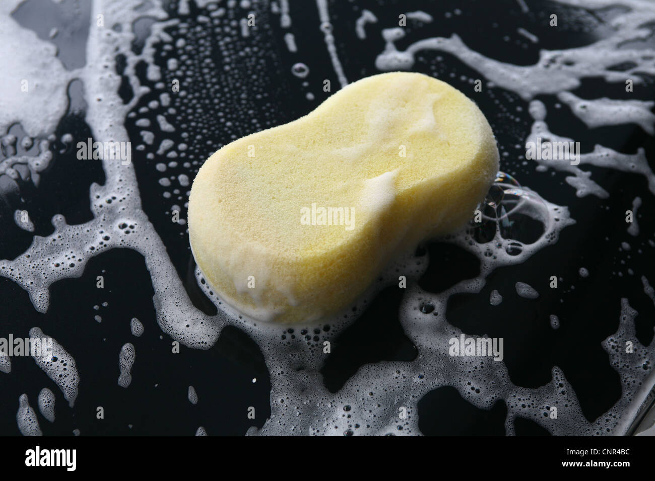 sponge washing on black car color Stock Photo - Alamy
