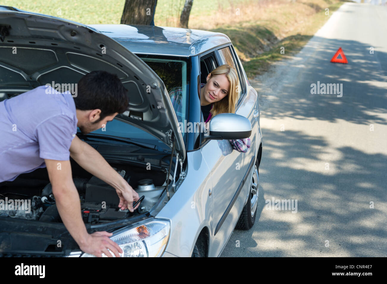 Car troubles couple starting cables broken vehicle on the road Stock ...