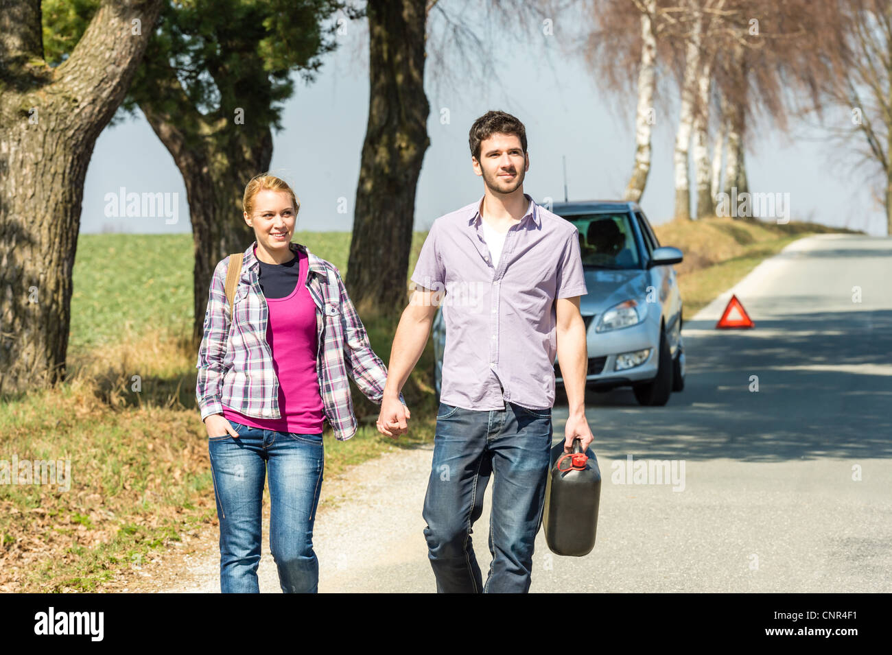 Running out of gas people walking for petrol can Stock Photo - Alamy