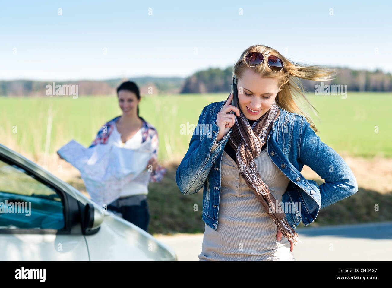 Lost with car two young women call for help Stock Photo - Alamy