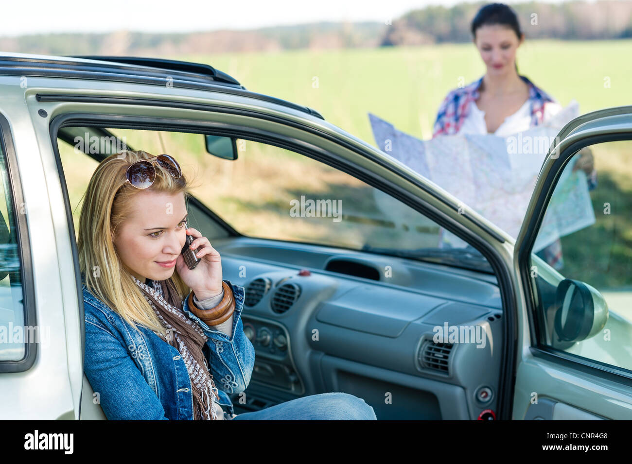 Lost with car two young women call for help Stock Photo - Alamy