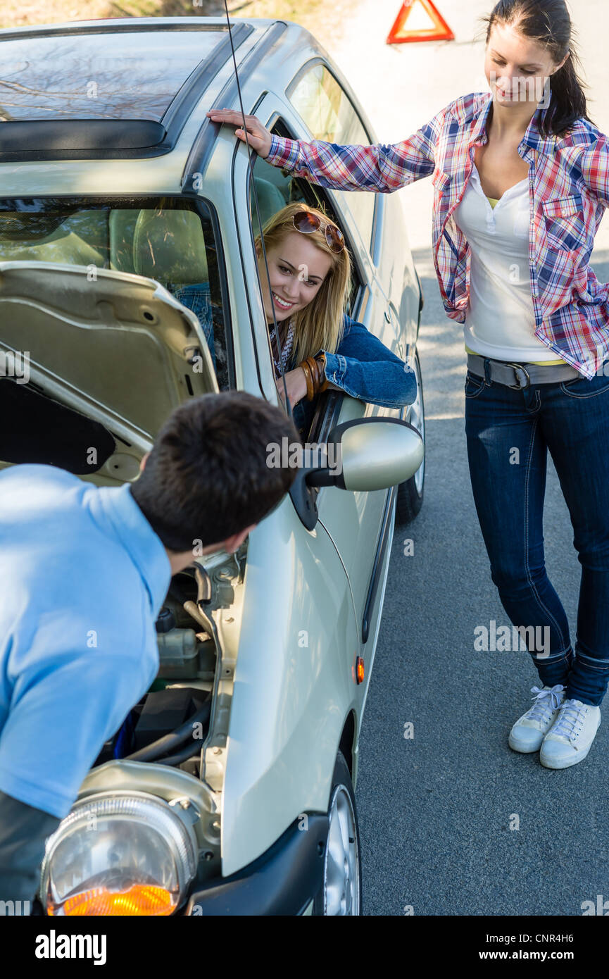 Car failure man help two female friends repair motor Stock Photo - Alamy